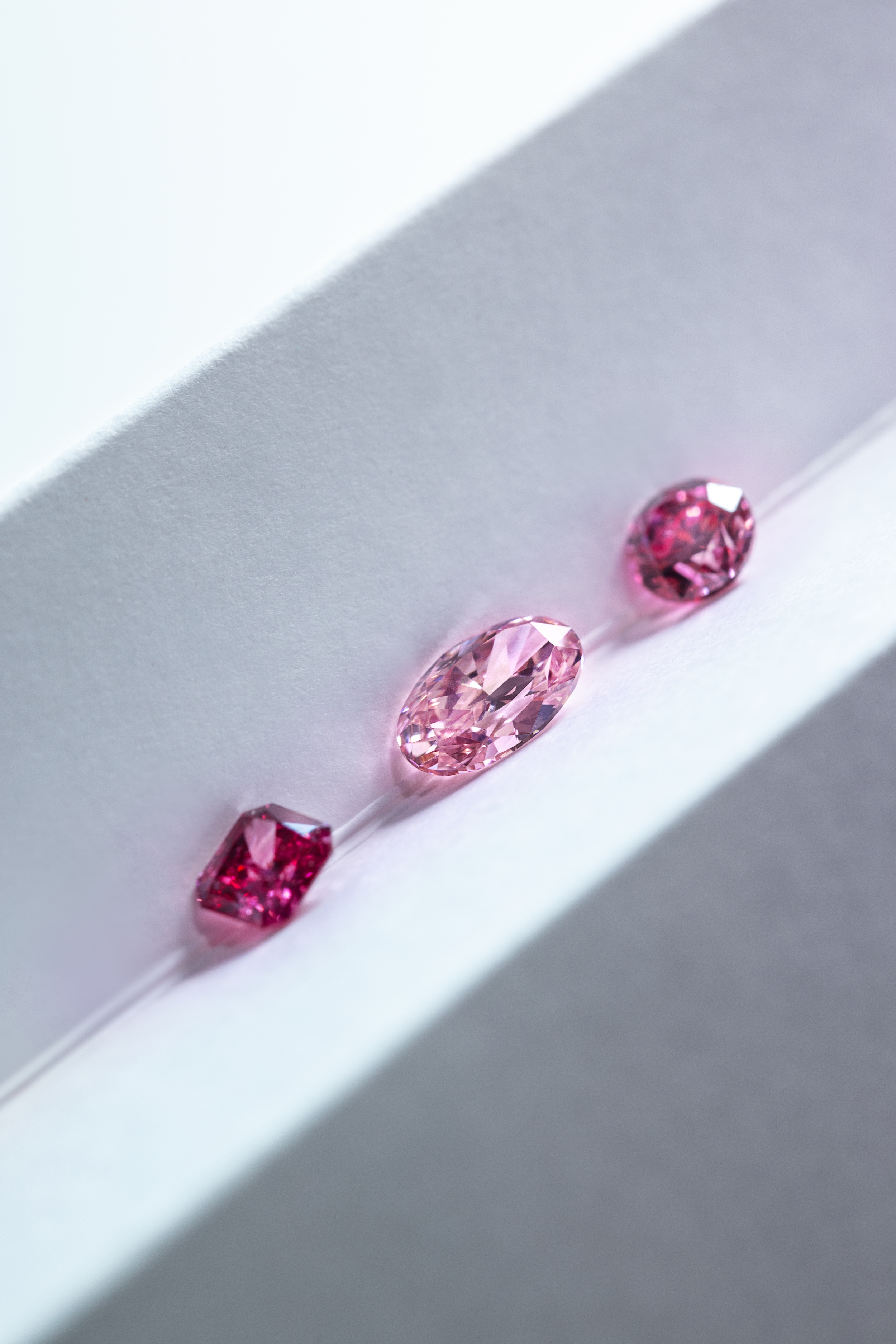 A Fancy Red diamond, a Fancy Intense Purplish Pink diamond and a Fancy ...