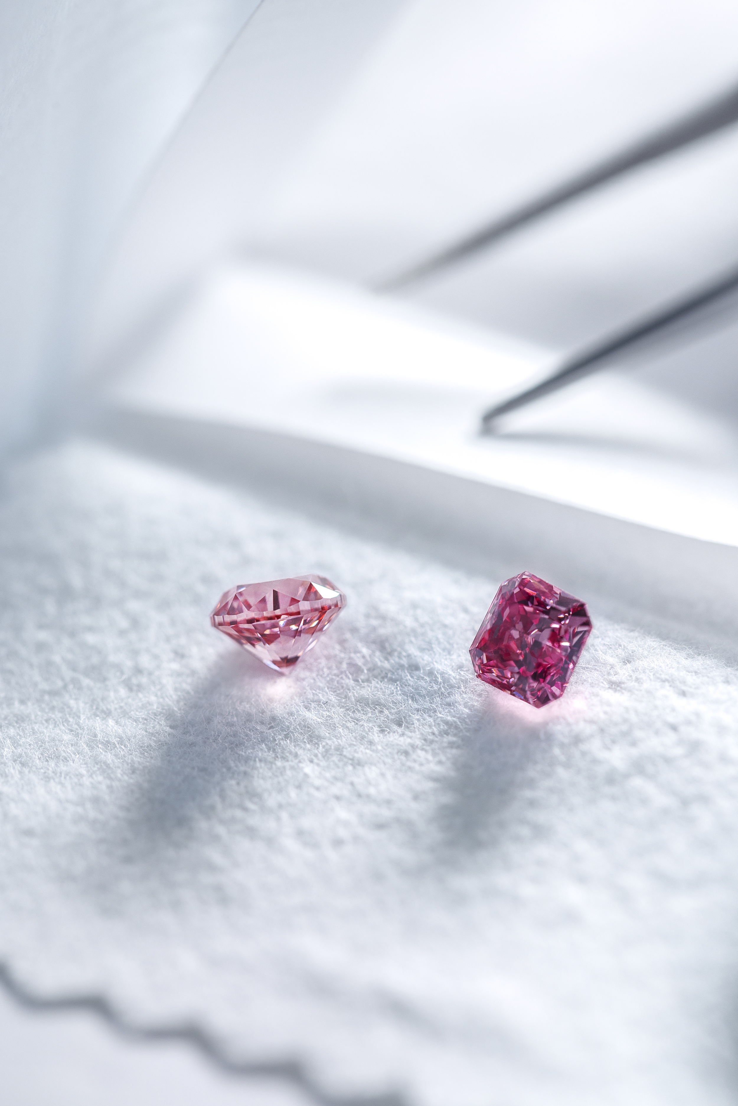 A Fancy Intense Pink diamond and a Fancy Red diamond from Argyle PinkTM ...